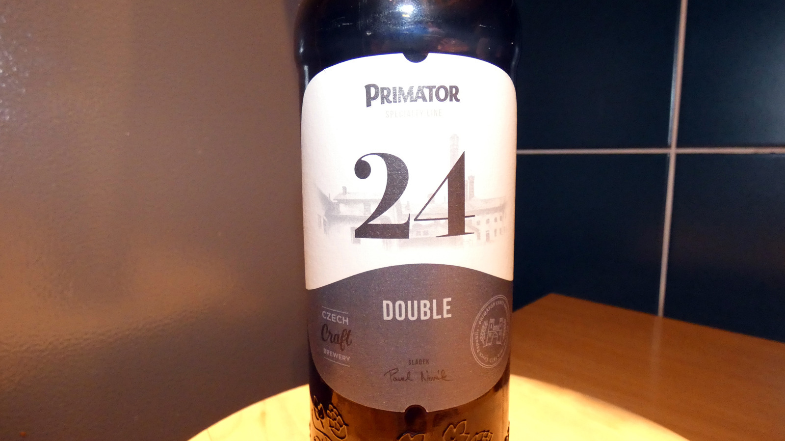 “Primator 24 Double” beer, with a cheese board or cake plate?